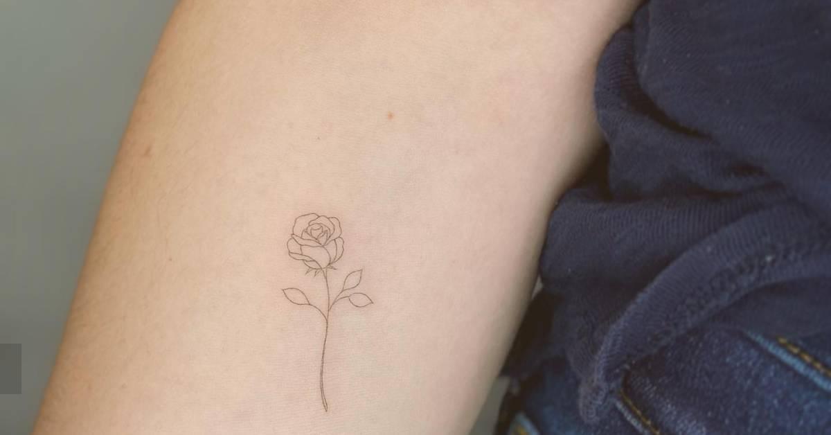 Fine line style rose tattoo located on the inner