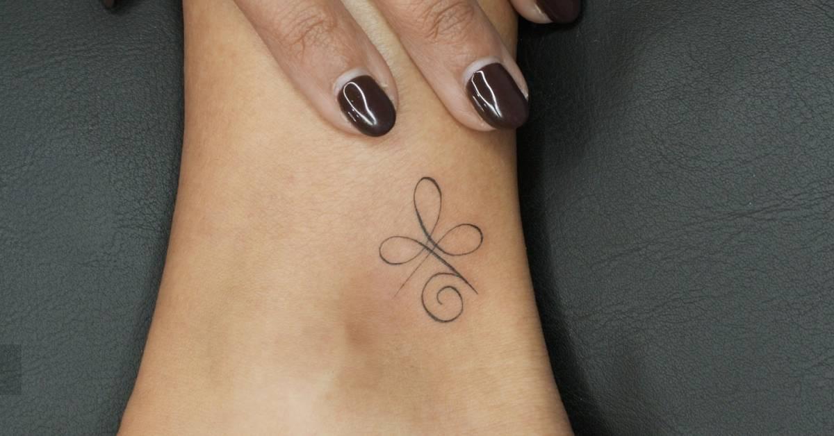 Begin anew Zibu symbol tattooed on the ankle.