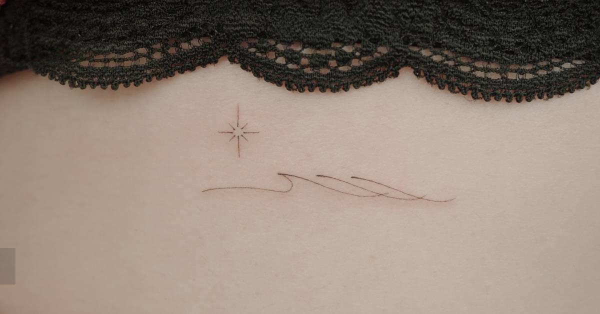 Fine line style north star and wave tattoo placed on