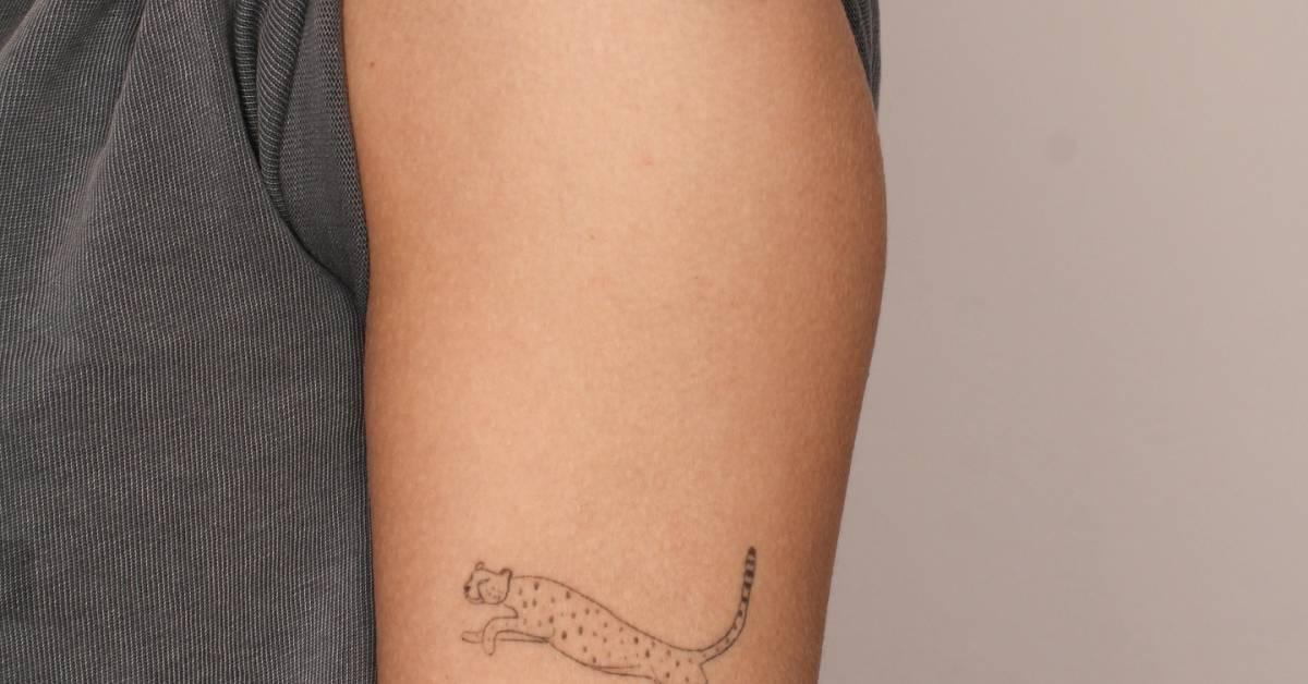 Healed fine line style leopard tattoo done on the upper