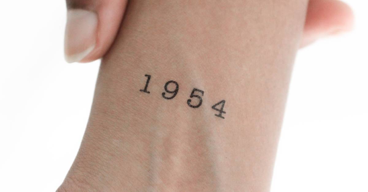 Birth year "1954" temporary tattoo located on the