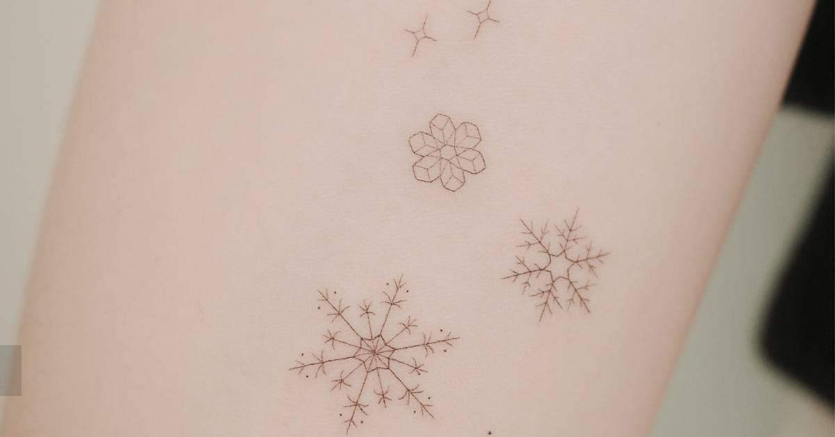 Fine line style snowflakes tattooed on the inner