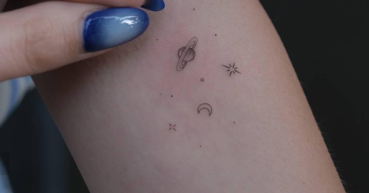 Little universe tattoo in minimalistic style placed on