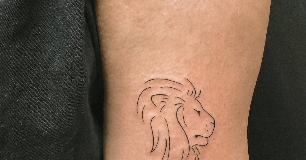 Fine line style lion portrait tattoo placed on the