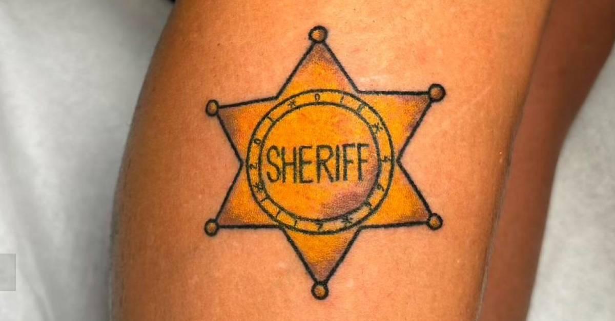 Hand poked Sheriff star tattoo located on the calf.