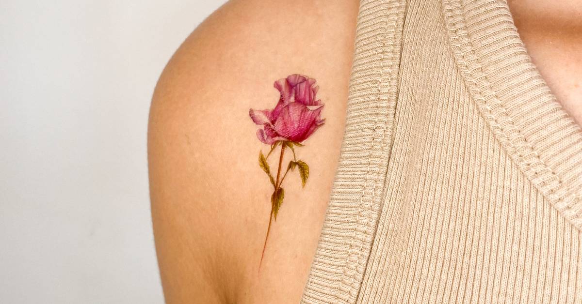 Fuchsia rose temporary tattoo located on the shoulder.