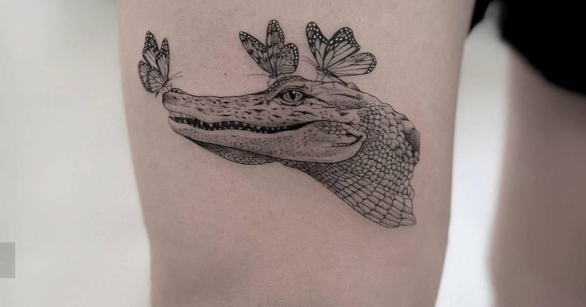 Illustrative style alligator and butterflies tattoo