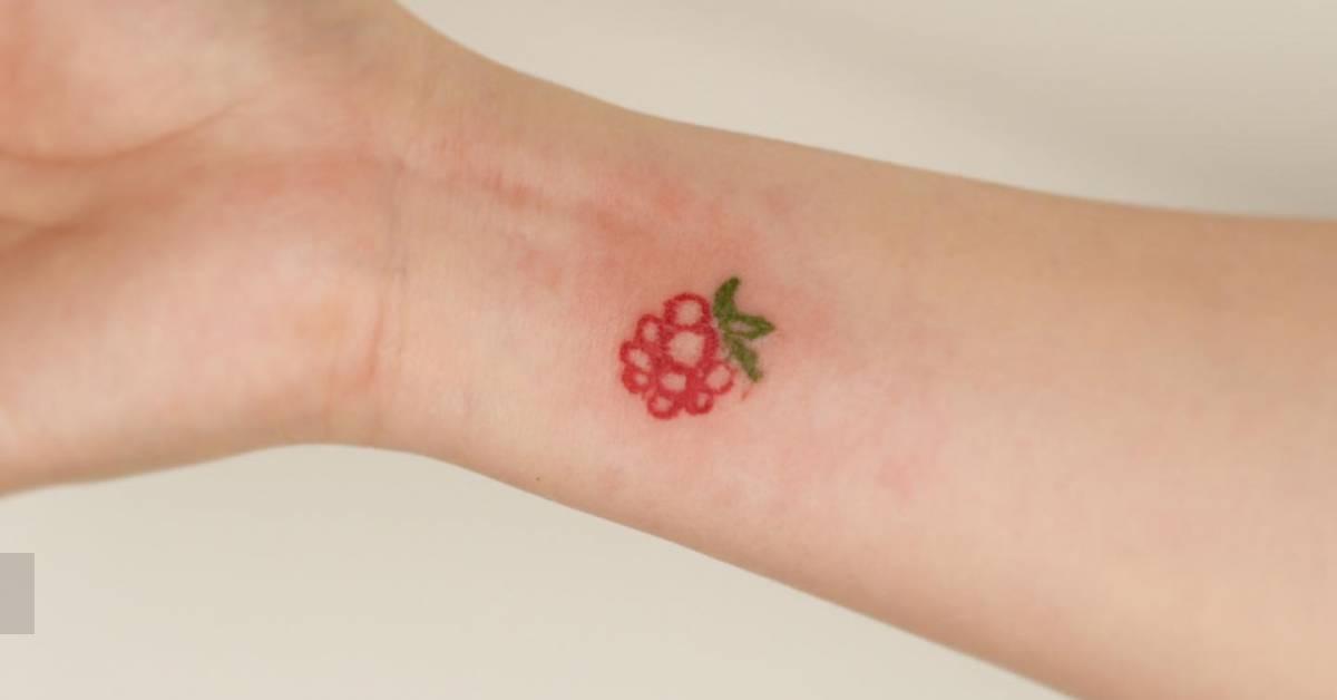 Minimalistic crayon effect raspberry tattoo located on