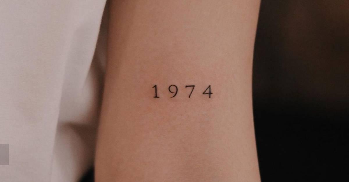 "1974" lettering tattoo located on the bicep.
