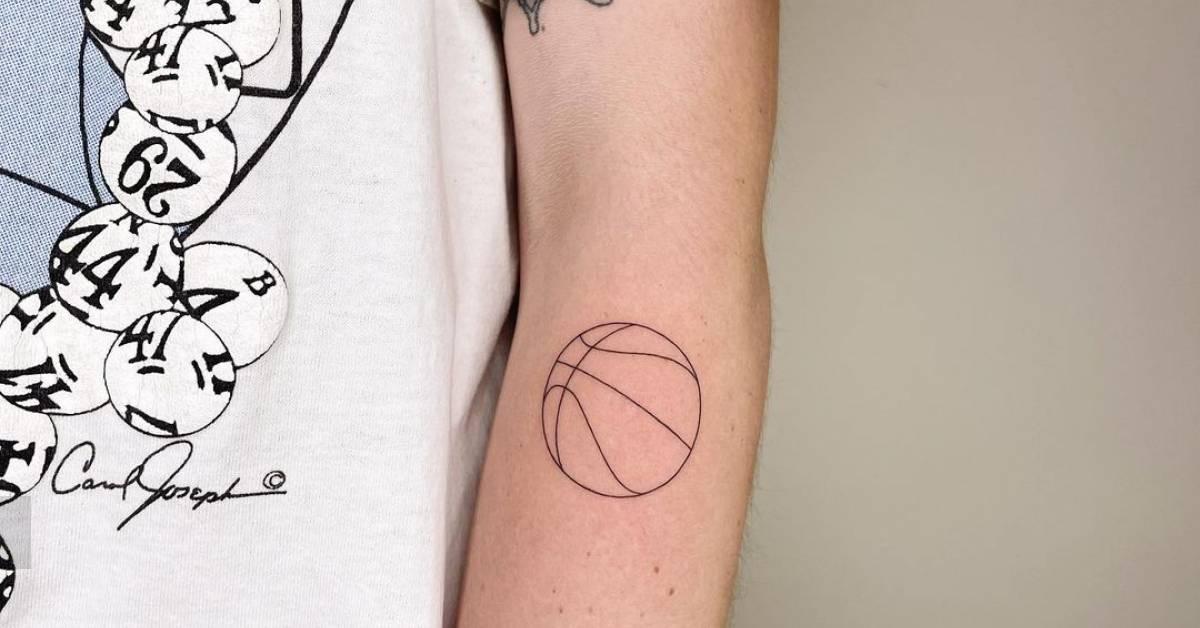 Minimalistic basketball ball tattoo located on the