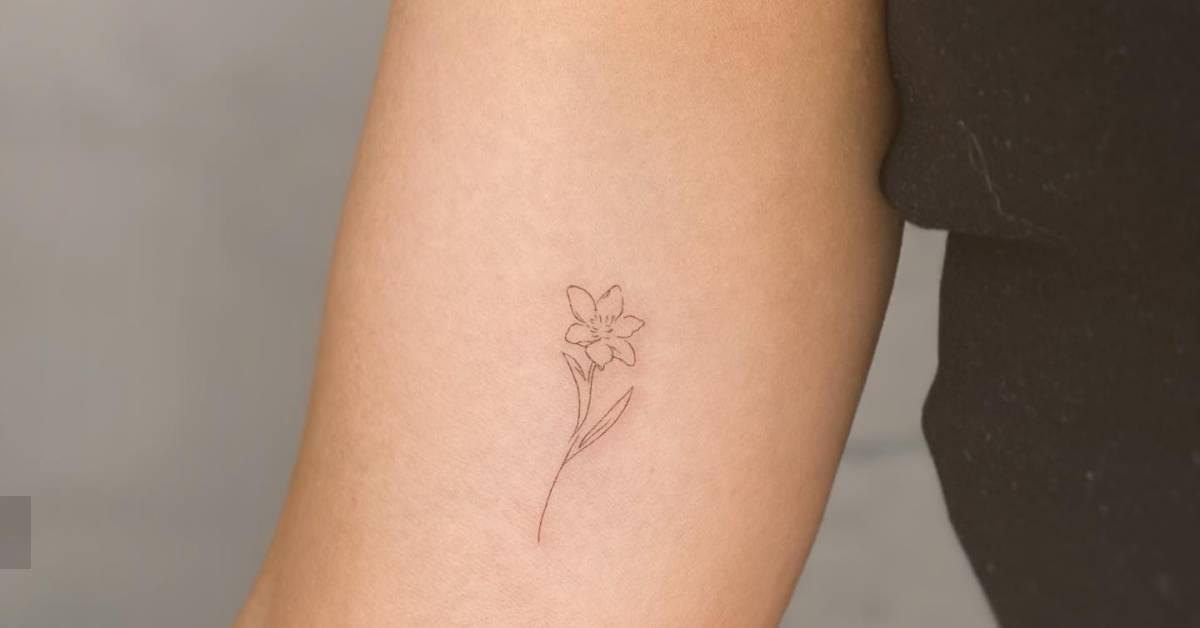 Fine line style lily flower tattoo placed on the inner