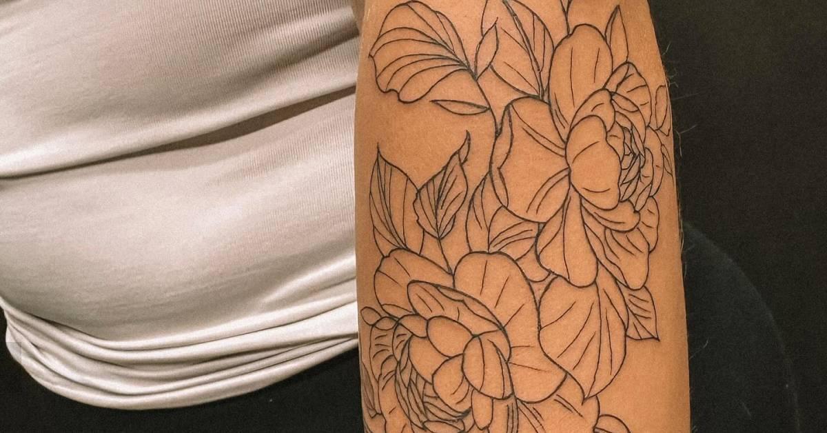 Fine line style peonies tattoo located on the forearm.