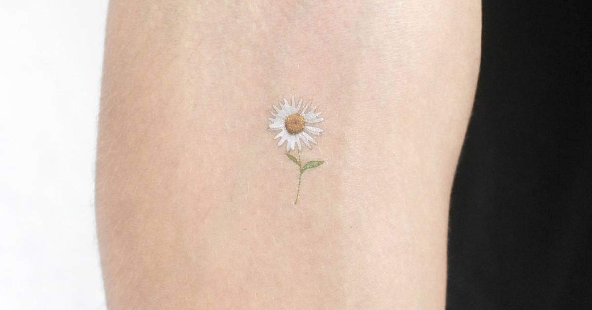 Small daisy flower temporary tattoo placed on the inner