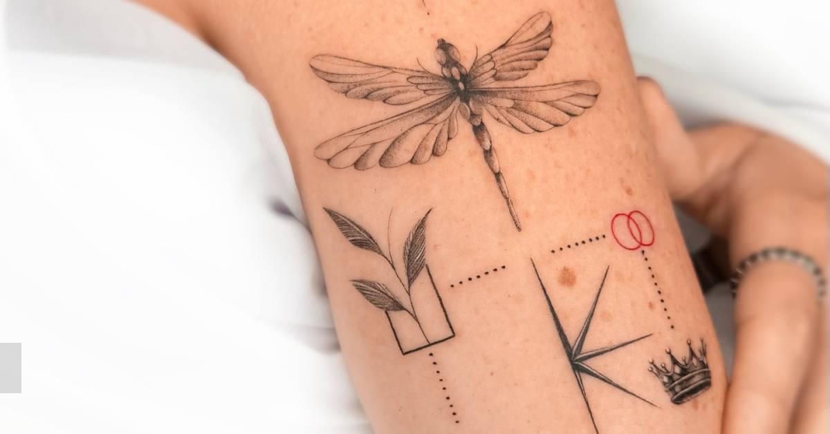 Graphic style upper arm composition tattoos.
