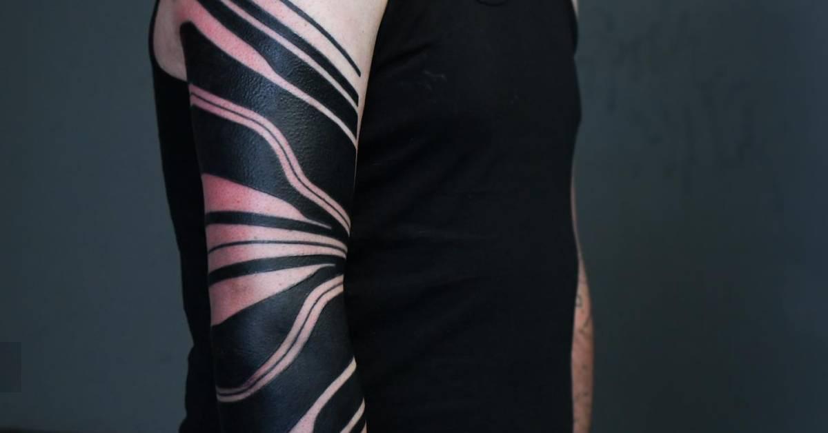 Cybernetic design tattooed on the arm, blackwork style.