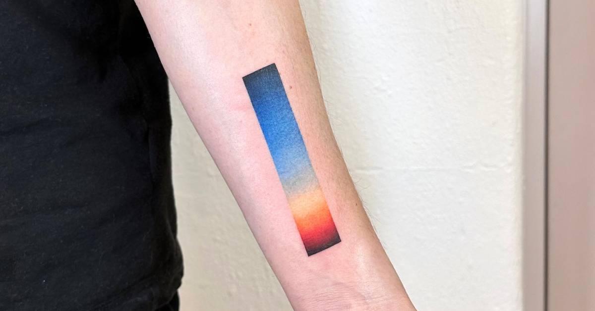 Spectrum tattoo located on the wrist, watercolor style.