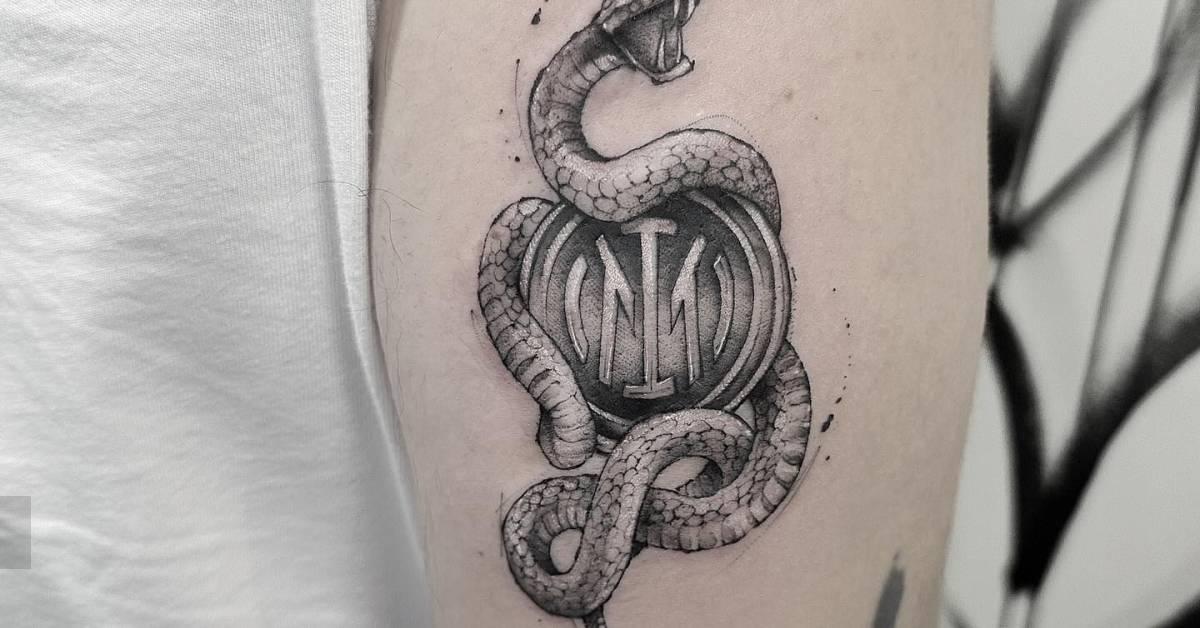 Sketch work style snake and Inter Milan tattoo located