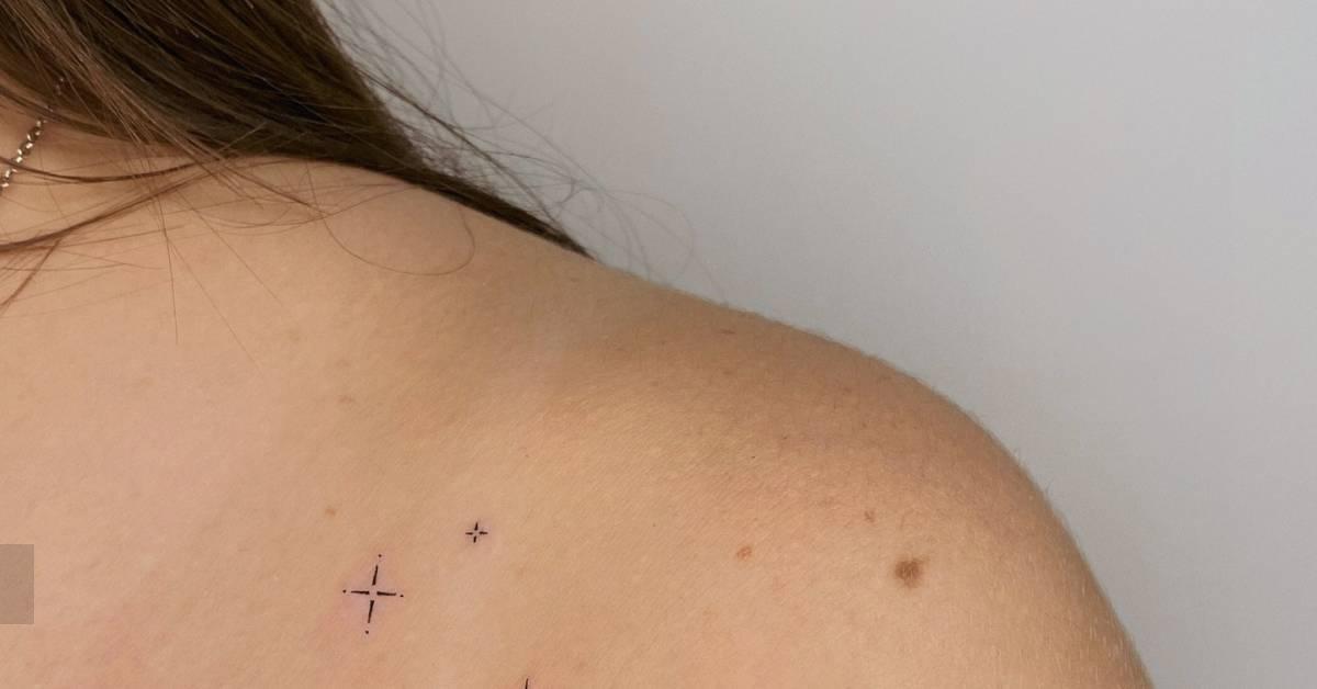 Sparkling stars tattoo in minimalistic style located on