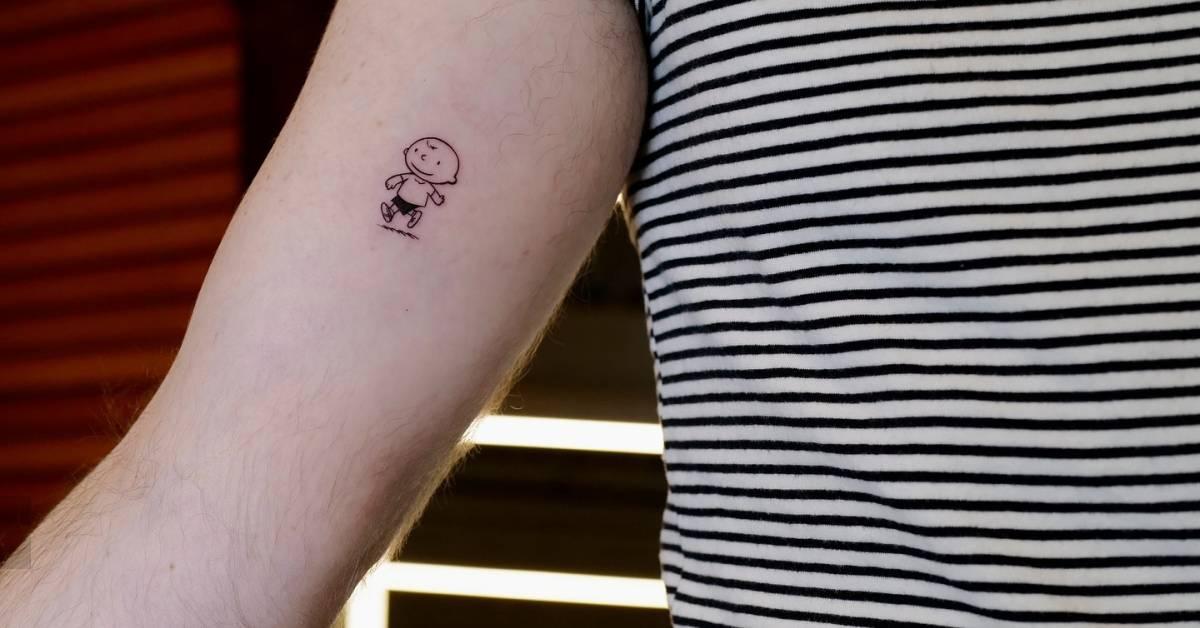 Charlie Brown tattoo located on the inner arm, cartoon