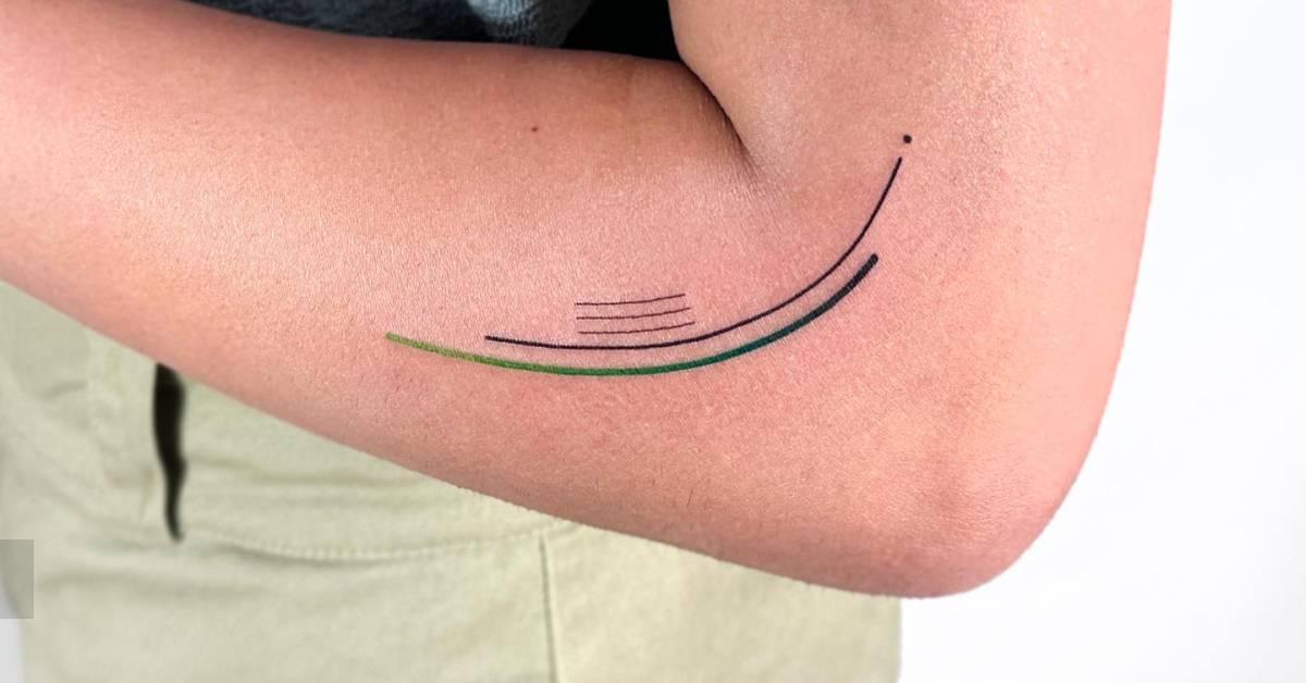 Abstract lines tattoo located on the elbow.
