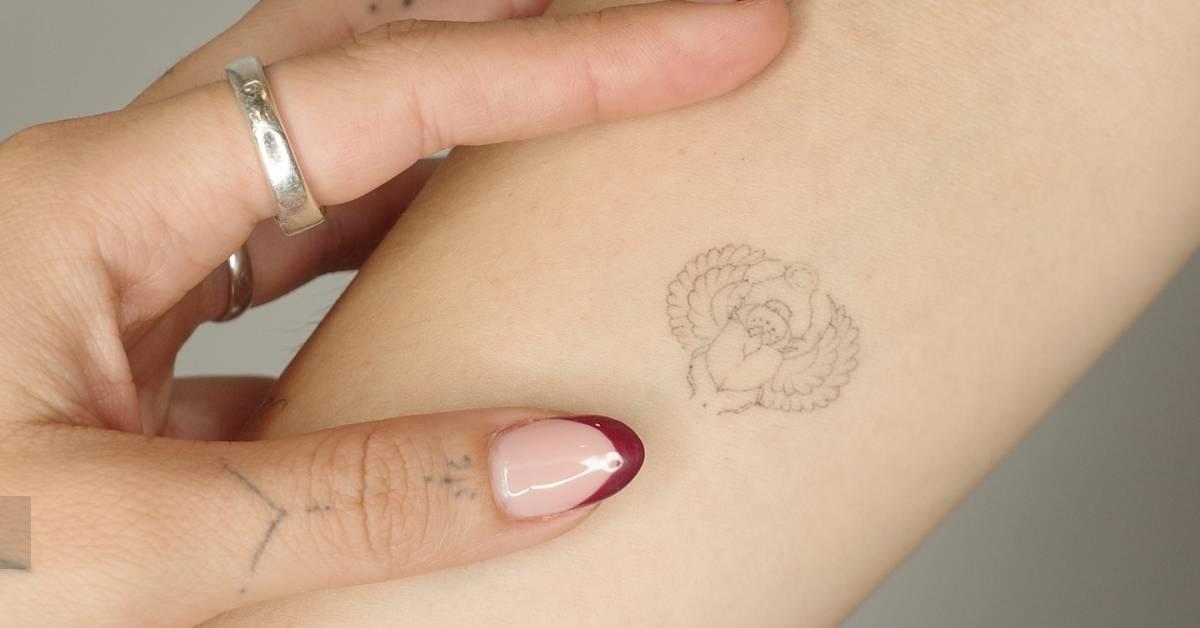 Healed fine line scarab tattoo done on the inner