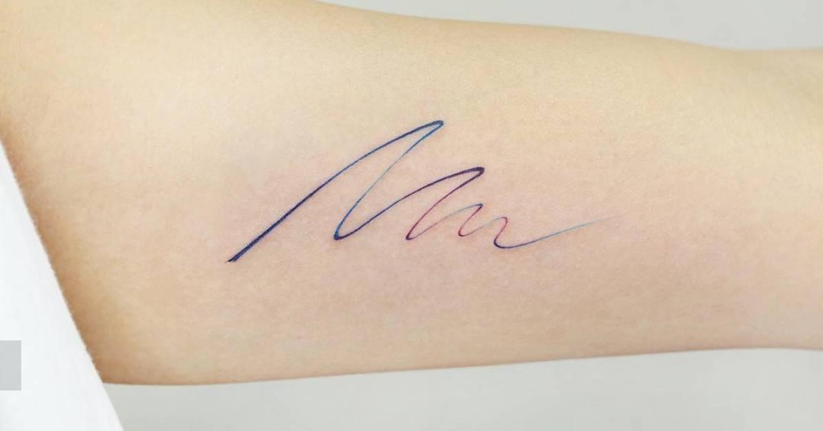 Spectrum scribble tattoo located on the inner arm.