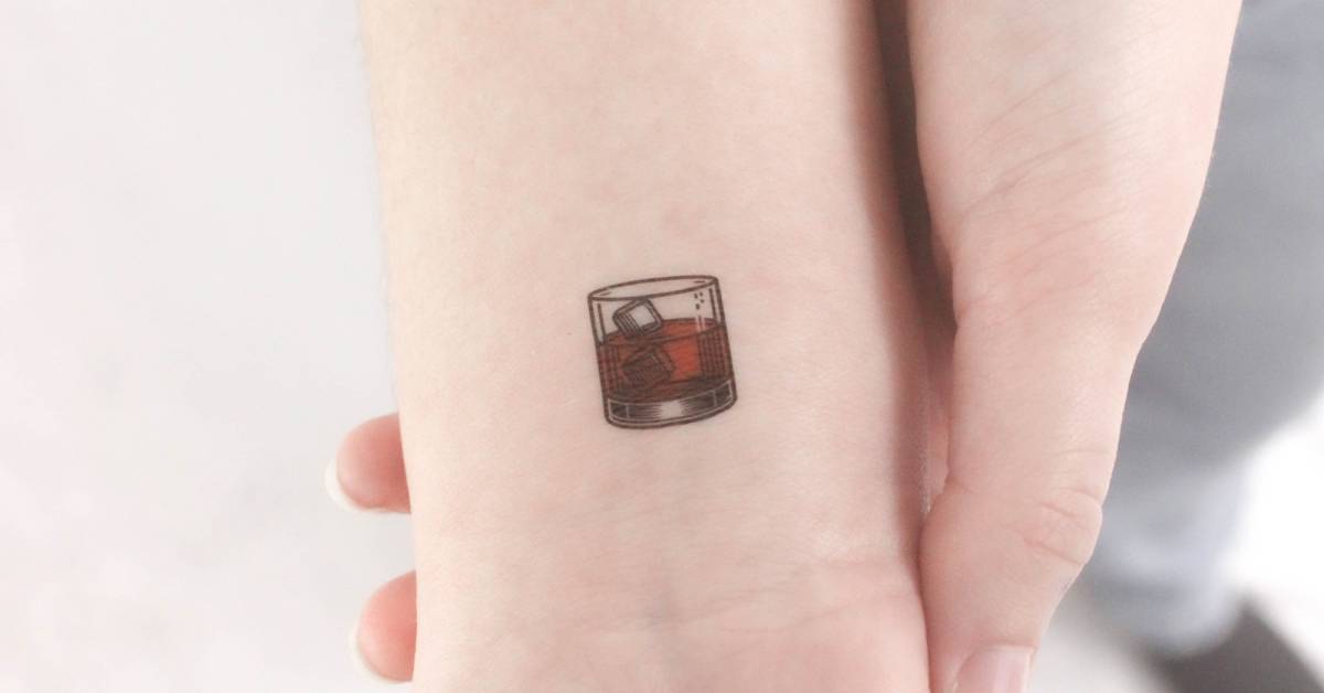 Little glass of whisky temporary tattoo placed on the