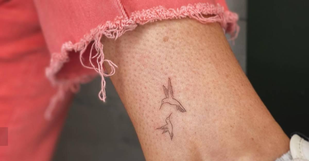 Fine line style hummingbirds tattoo located on the