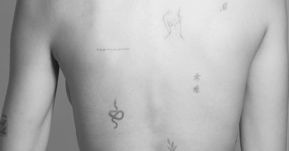 Back composition tattoos in fine line style.,