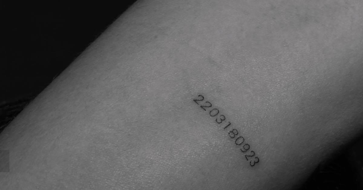 Number tattoo located on the inner forearm.