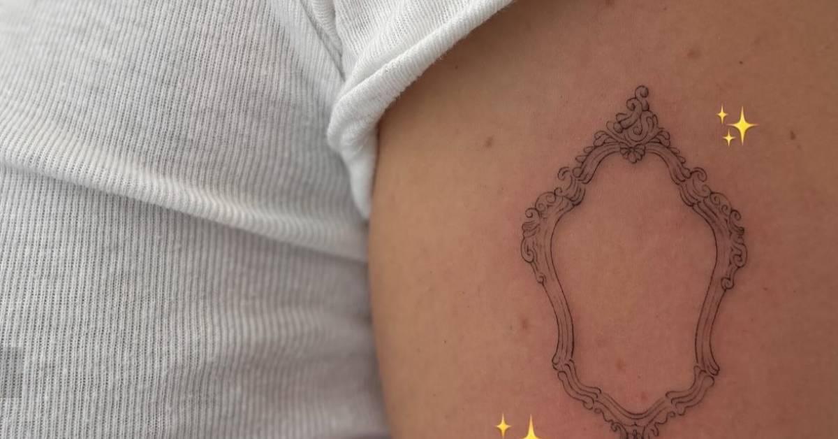 Frame tattoo in fine line style located on the upper