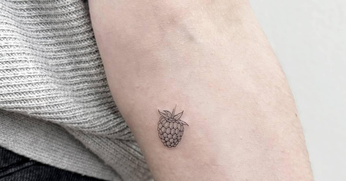 Little illustrative style raspberry tattoo located on