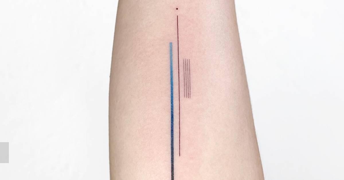 Spectrum lines tattoo located on the inner forearm,
