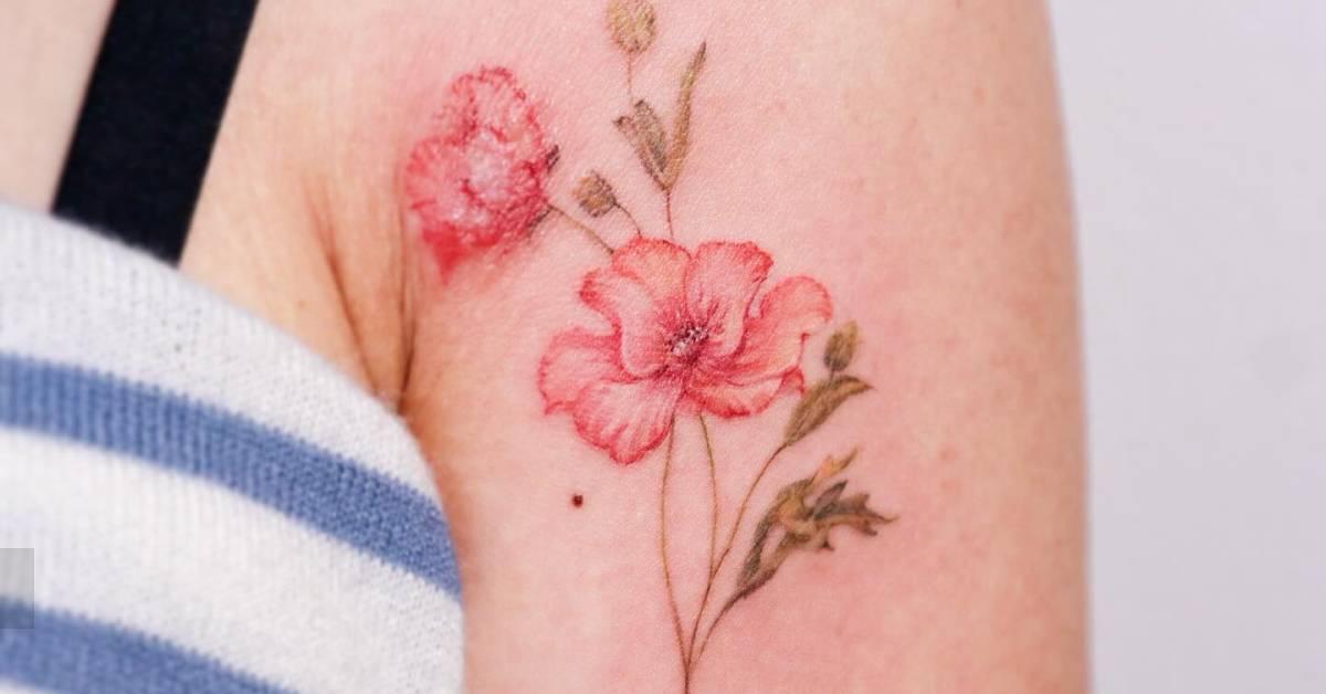 Opium poppies tattooed on the upper arm, done in