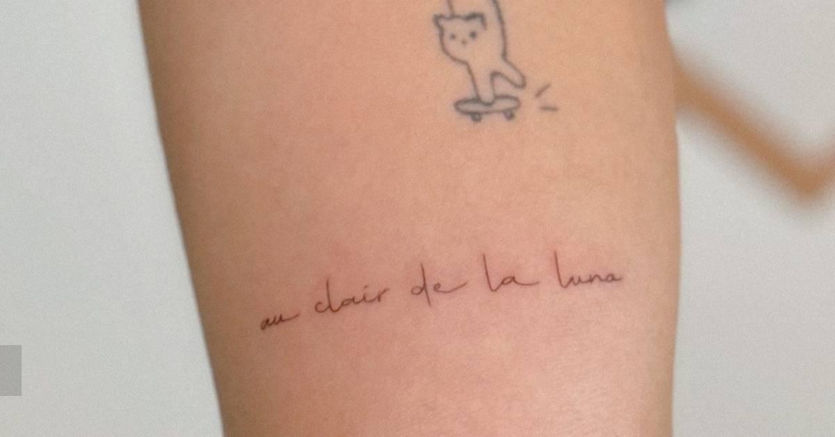 "Au clair de la luna" lettering tattoo placed on the