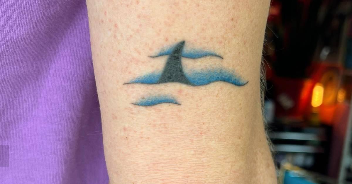 Shark Fin tattoo placed on the tricep, traditional