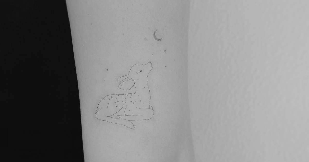 Fine linen style fawn tattoo located on the tricep.