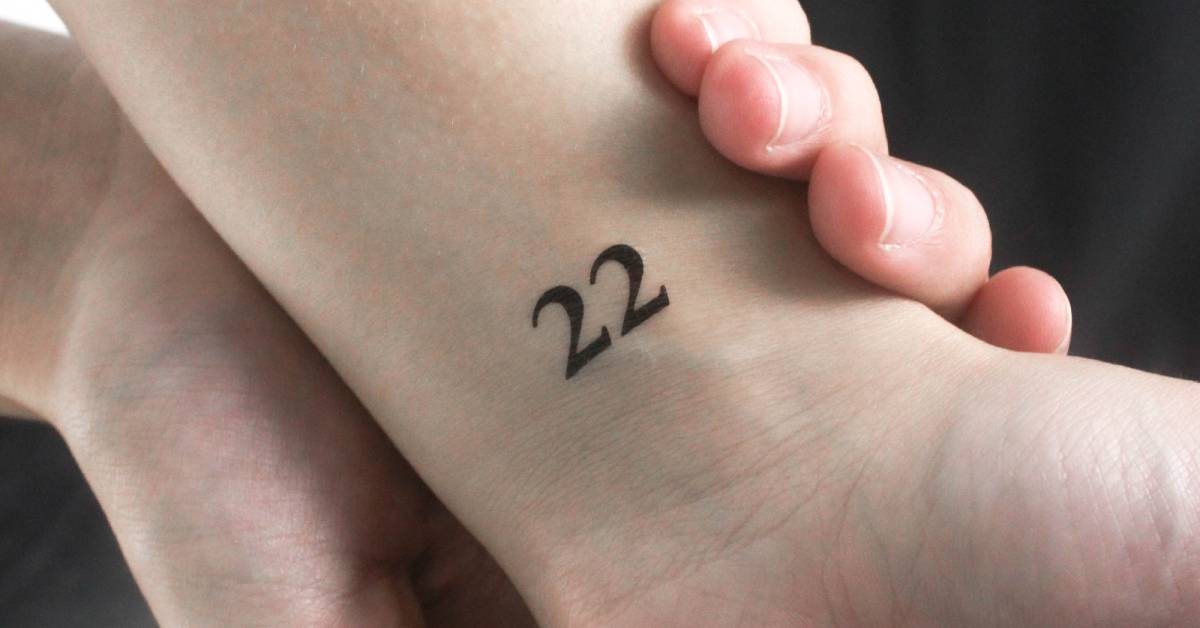 Little number "22" temporary lettering tattoo done on