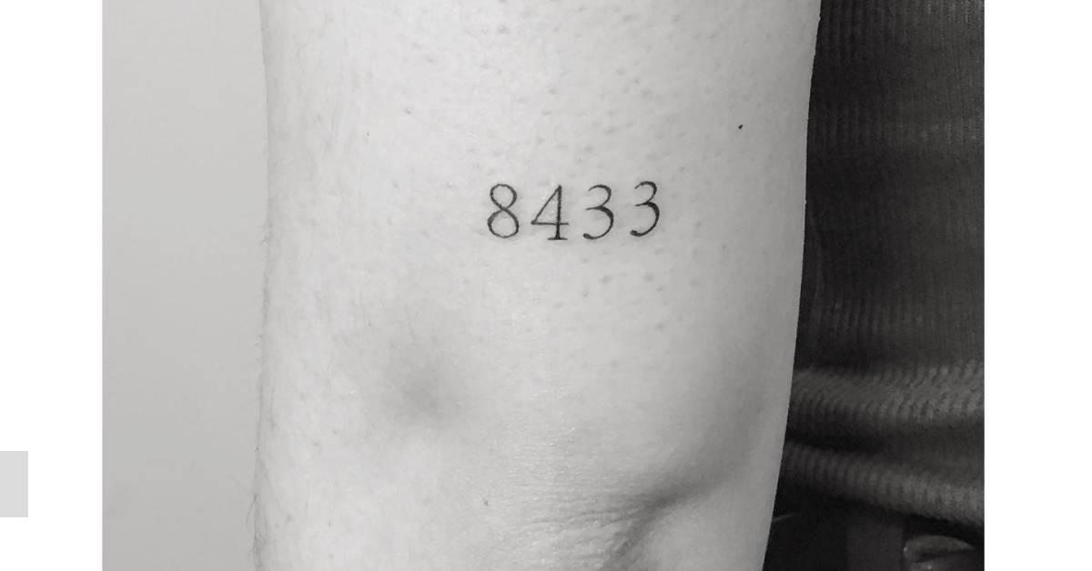 Lettering tattoo of the number "8433" located on the