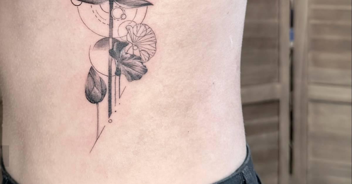 Graphic style lotus flower tattoo located on the rib.