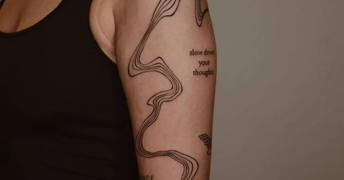 Abstract tattoo located on the upper arm.