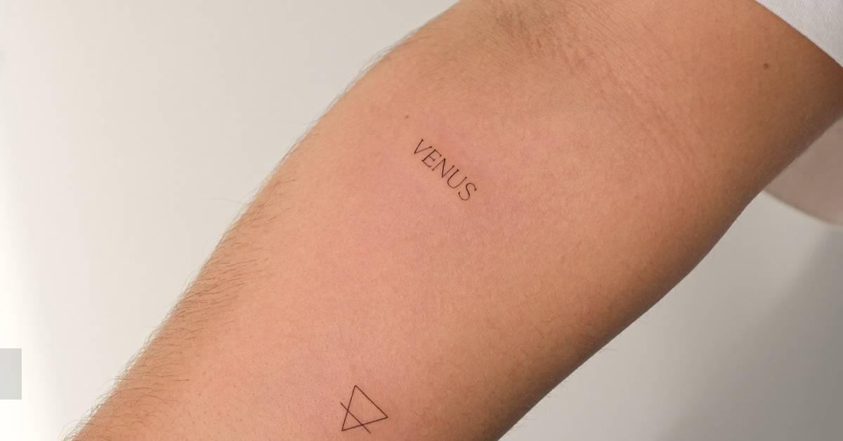 "Venus" and earth alchemy symbol tattooed on the inner