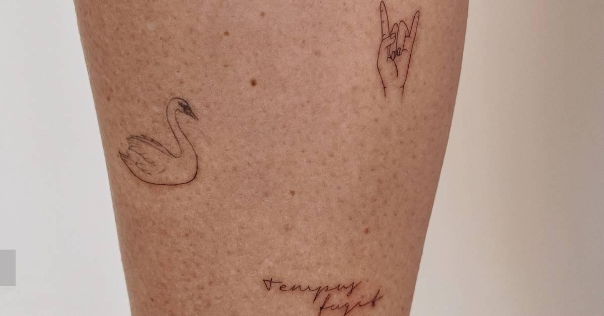 Swan, rock salute and "tempus fugit" tattoos located on