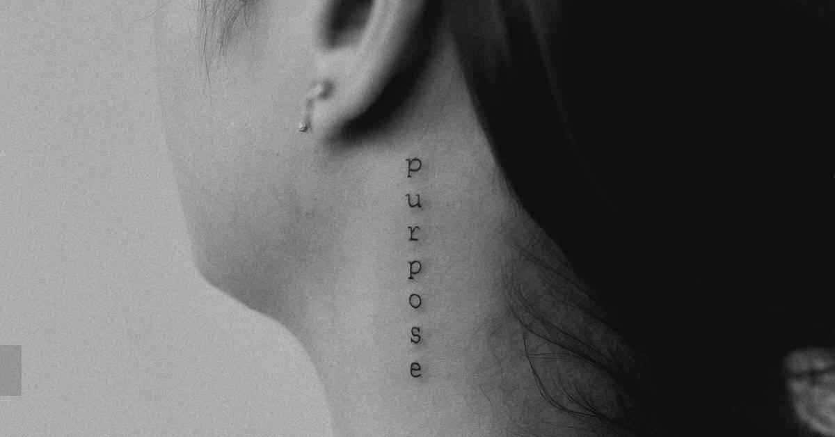 Lettering tattoo of the word "purpose" located on the