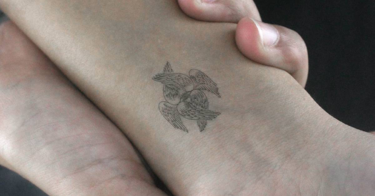 Fine line style seraphim temporary tattoo located on