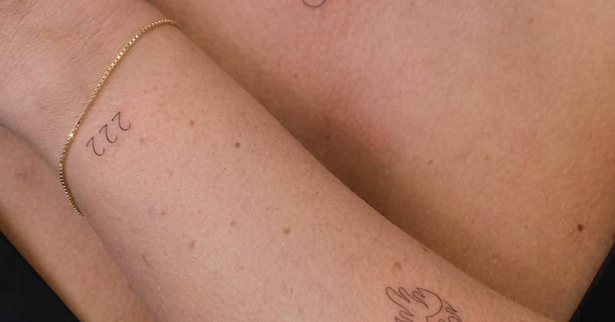Taurus symbol, number "222" and flaming heart tattoos