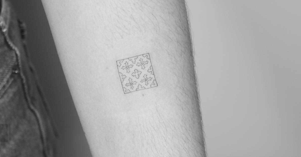 Small tile tattoo located on the inner forearm, fine