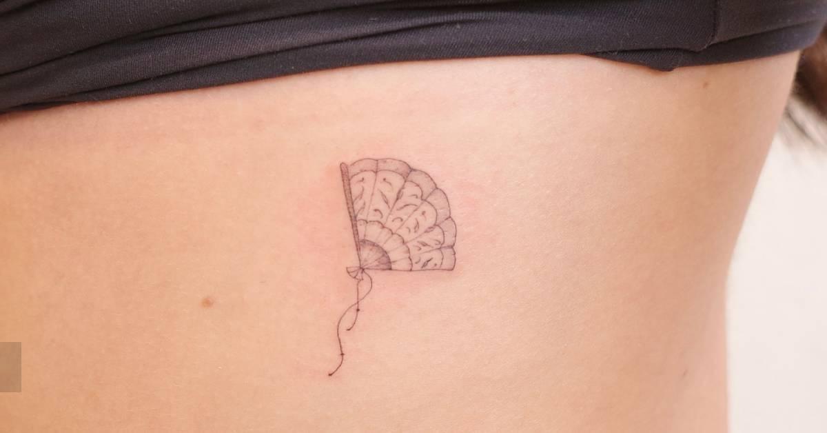 Hand fan tattoo placed on the rib, done in fine line