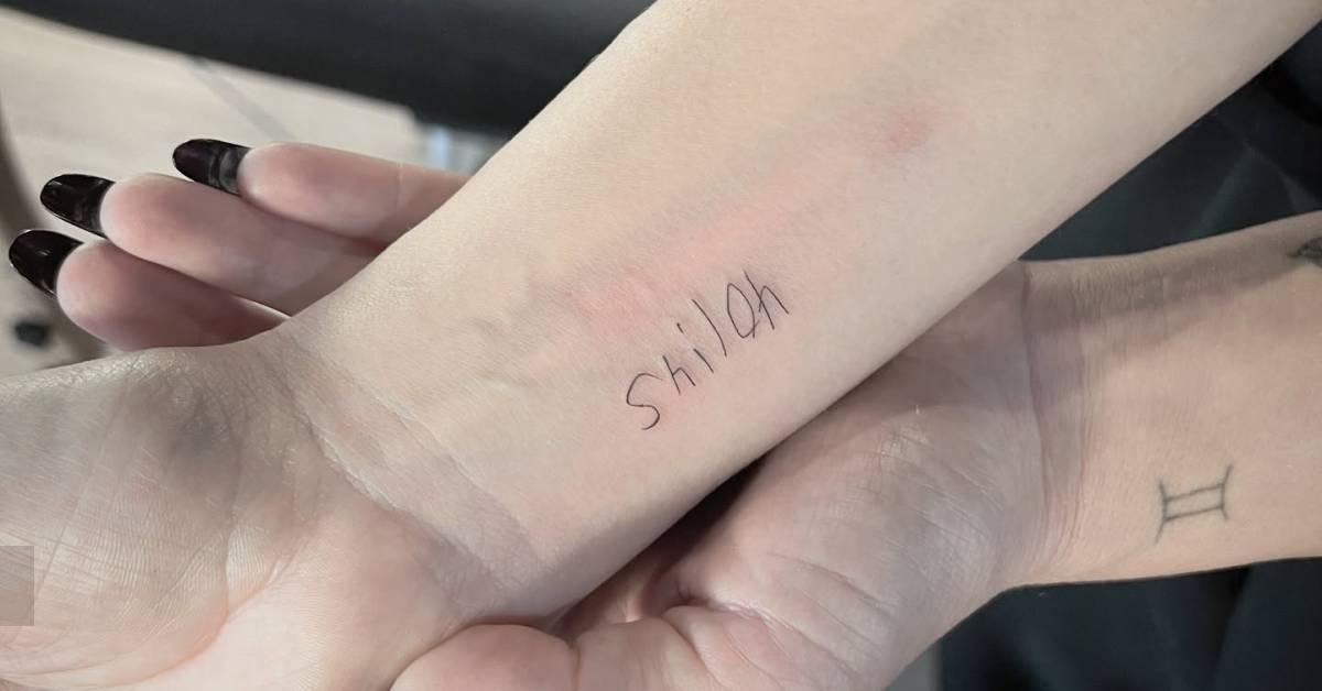 Handwritten name "Shiloh" tattooed on the wrist.