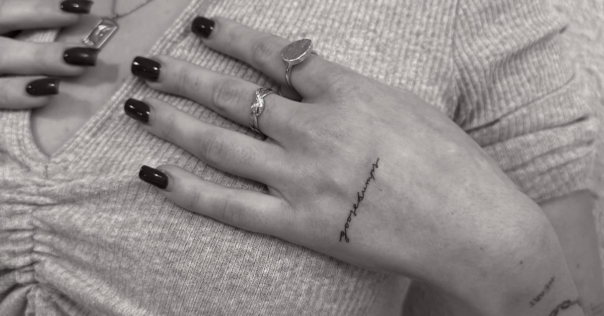 "Goosebumps" lettering tattoo located on the hand.